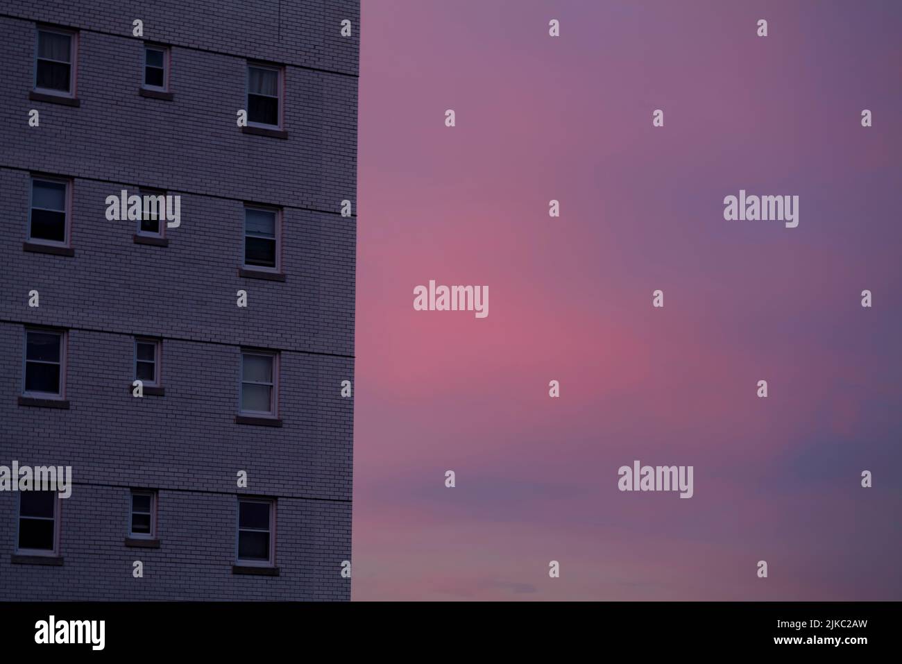 Pink Stratus clouds sunset sky behind the residential building with ...