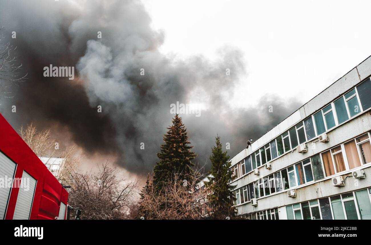 Black smoke in the sky from a fire in an office building Stock Photo ...