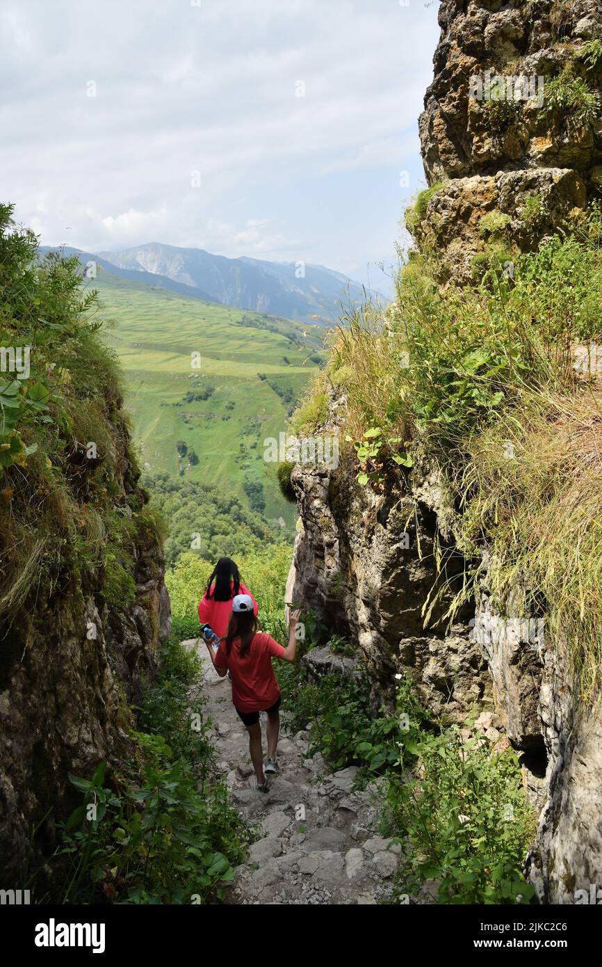 Two girls walk down through the narrow stone path leading to the Malta ...