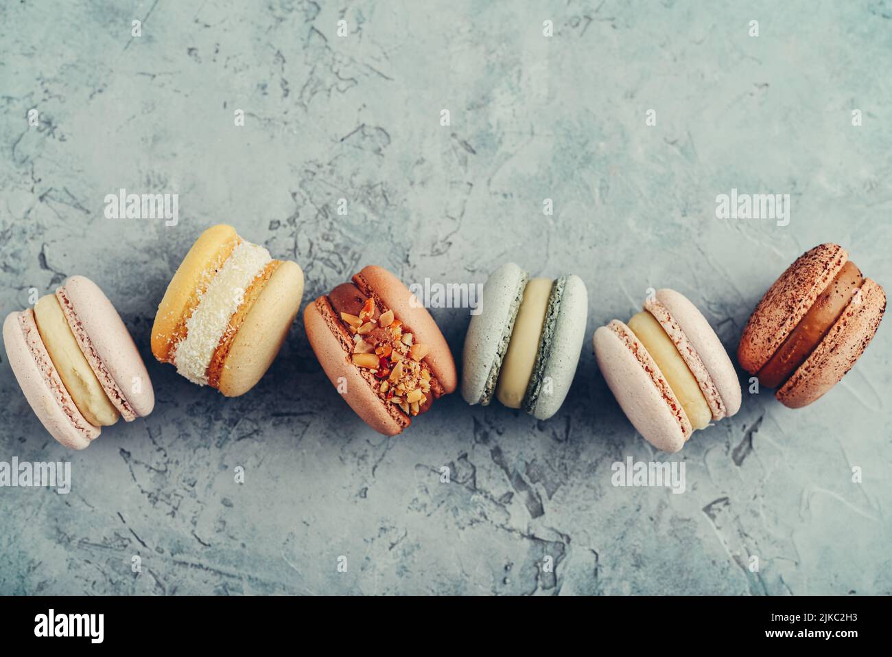 Colorful macarons on blue background, top view Stock Photo - Alamy