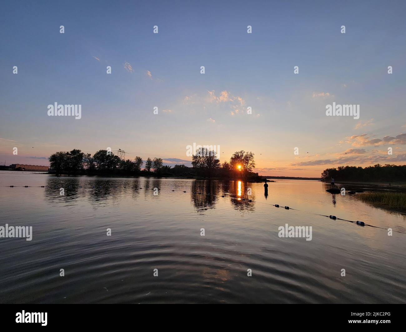 Beautiful view of tranquil lake with trees during sunset. A river ...