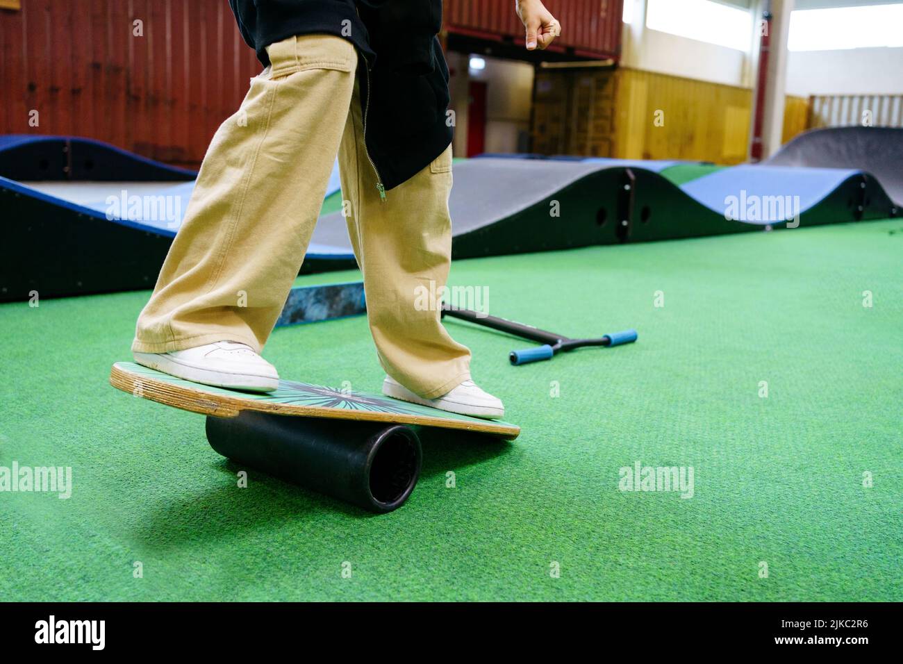 Girl on balance board indoor Stock Photo - Alamy