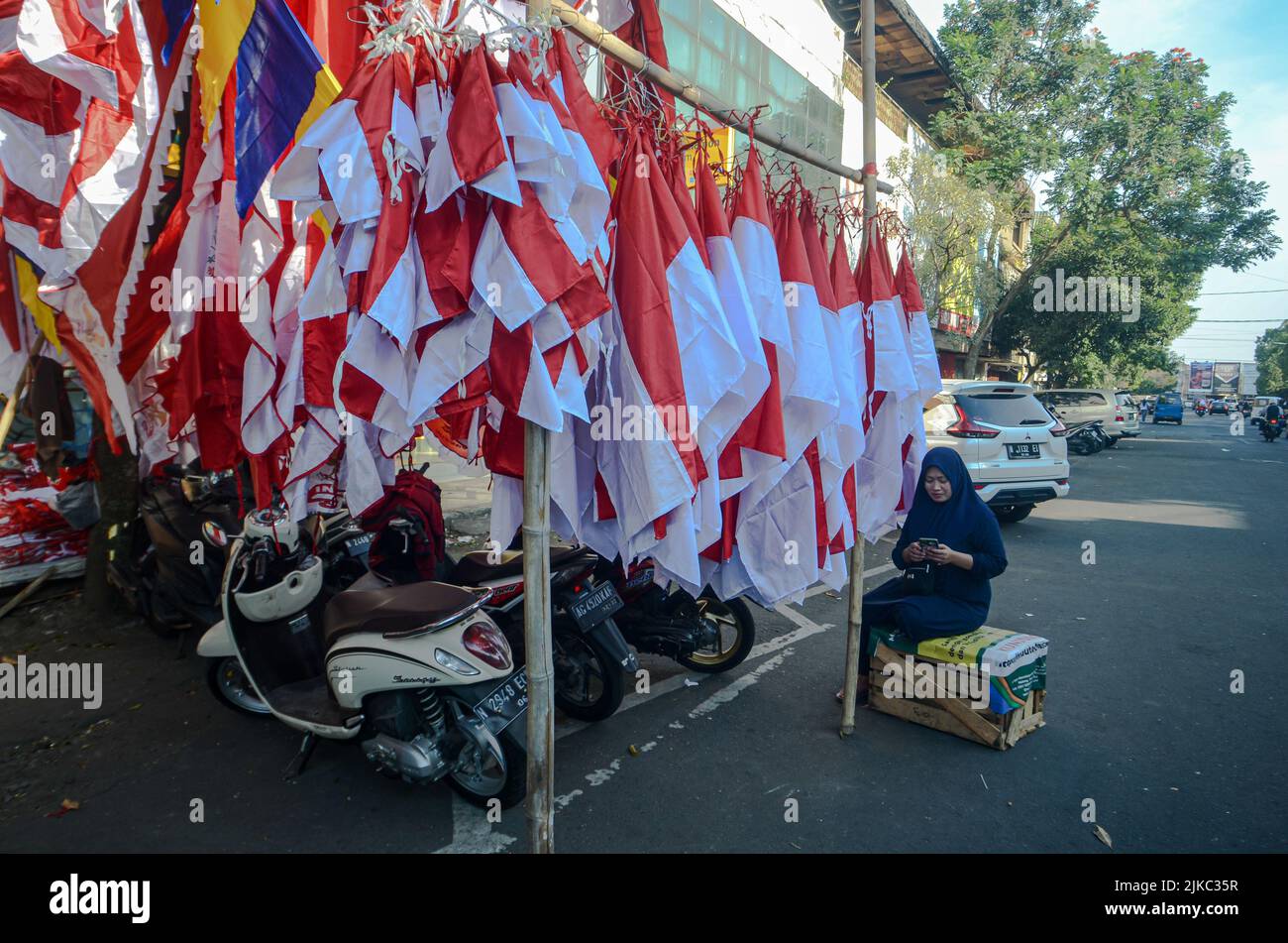 Malang, East Java, Indonesia. 1st Aug, 2022. A trader is seen selling Indonesian flags on the ...