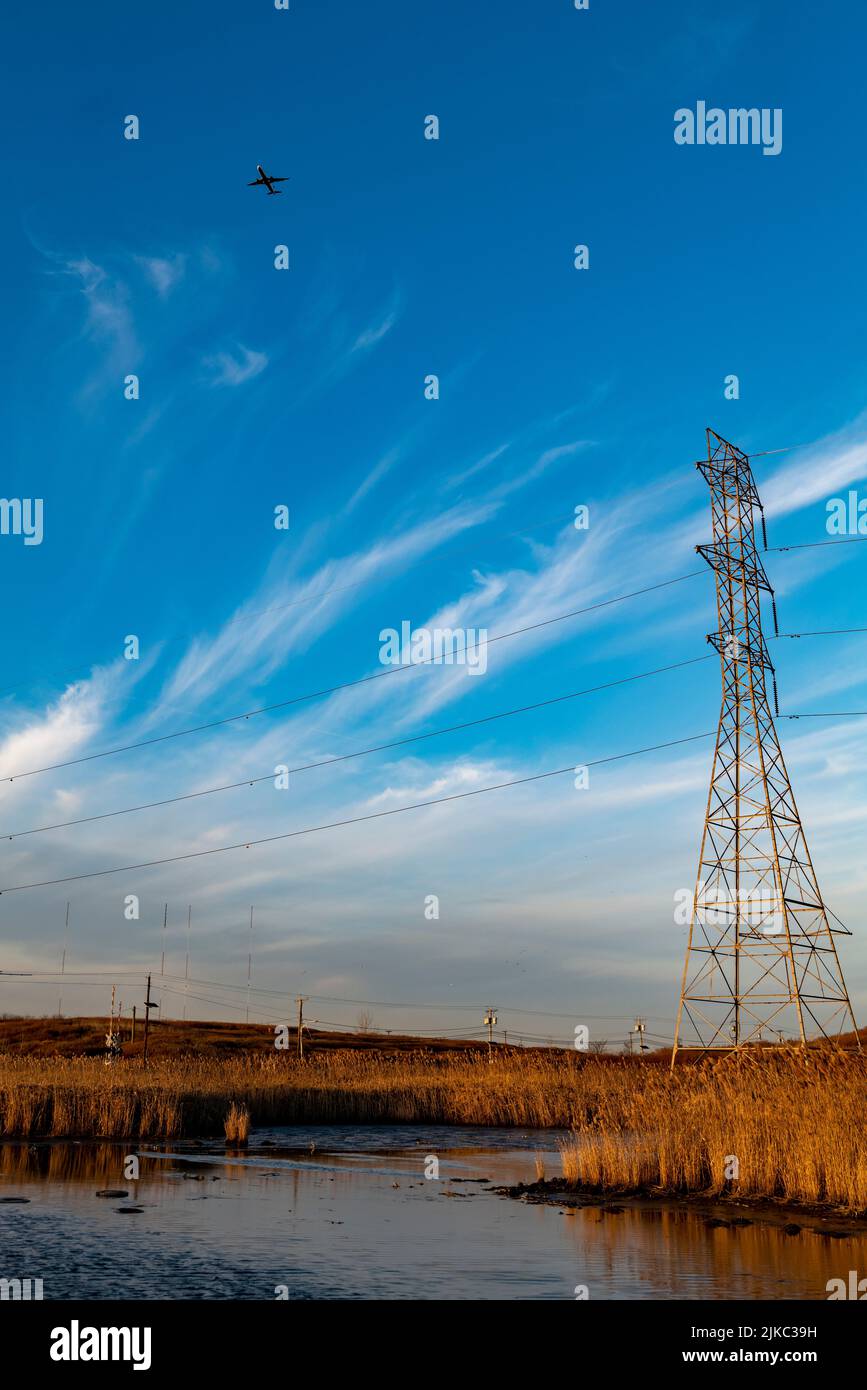 Low angle view of an airplane against the blue and cloudy sky, electric ...