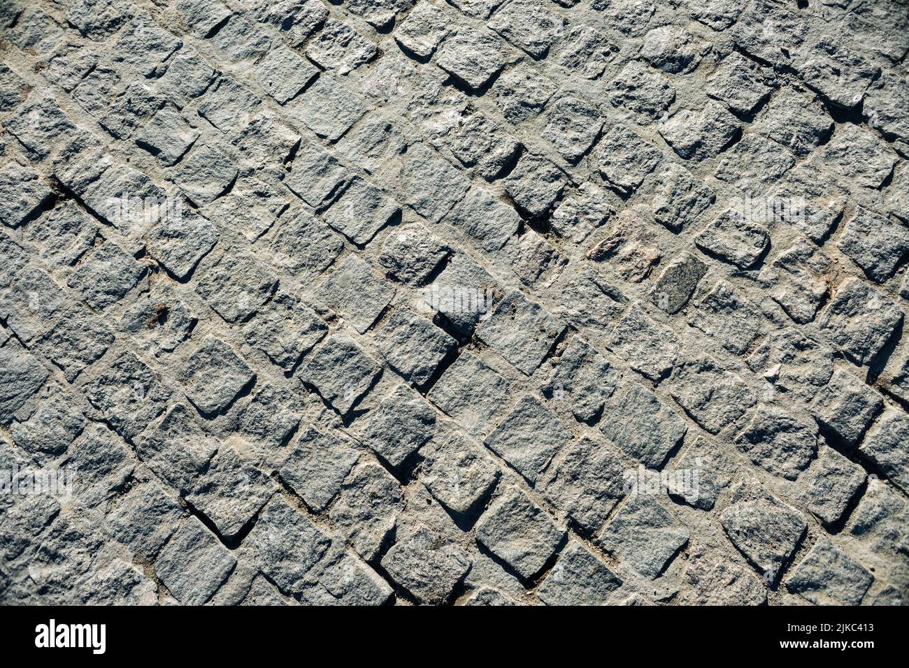 dirty pavement pavement, illuminated by bright sunlight. Background ...