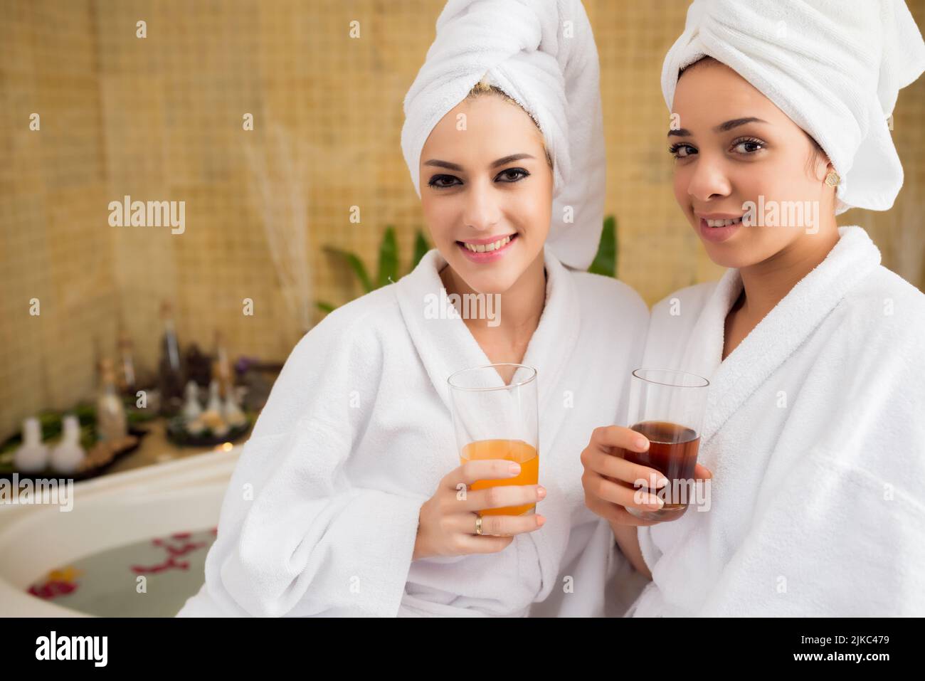 Multi-ethnic group of friends wearing towels and bathrobes posing for ...