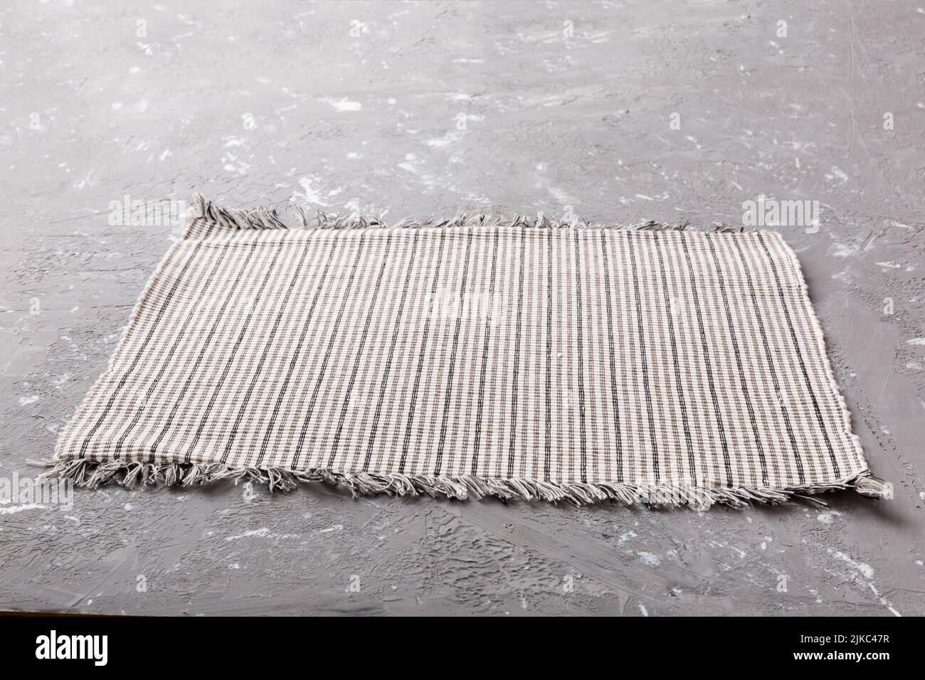 Perspective view of grey tablecloth for food on cement background ...