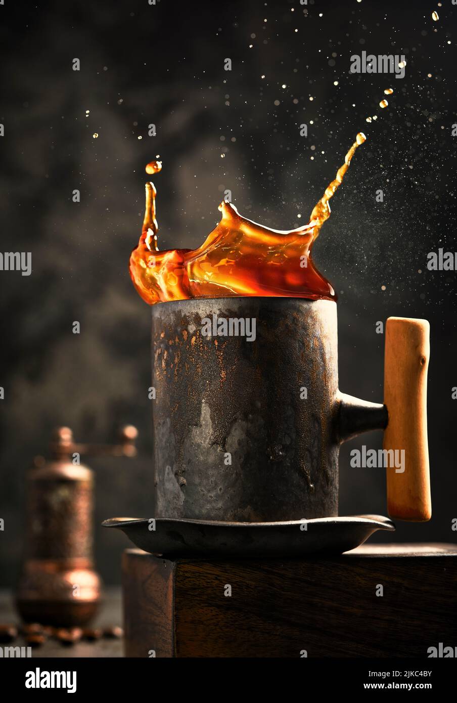 A vertical shot of coffee cup with splash Stock Photo - Alamy