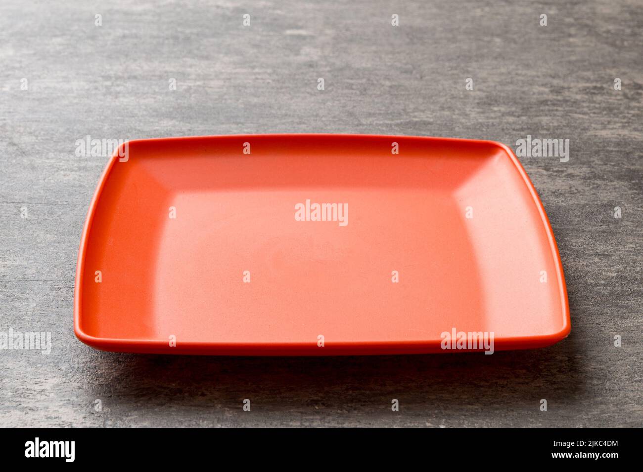 Perspective view of empty square plate on cement background. Empty ...