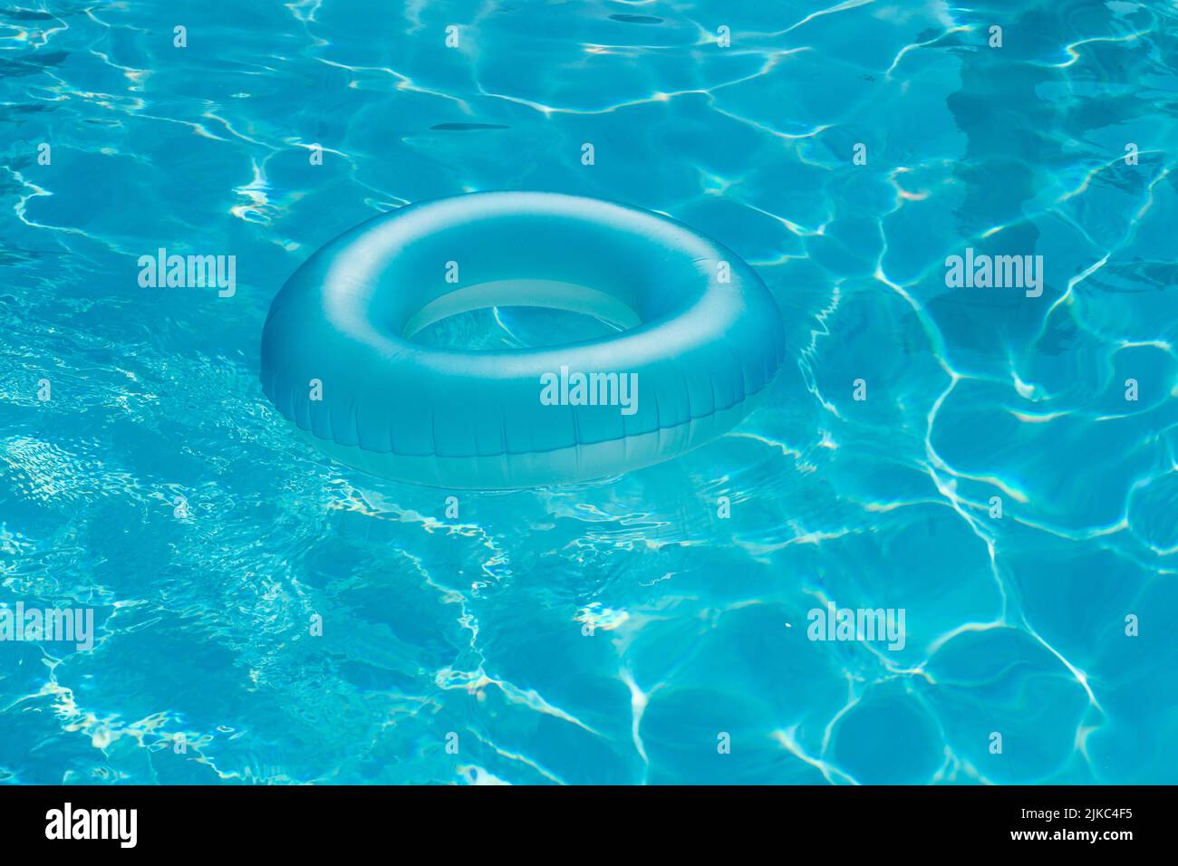 Blue summer pool rubber ring floating on a vacation swimming pool Stock ...