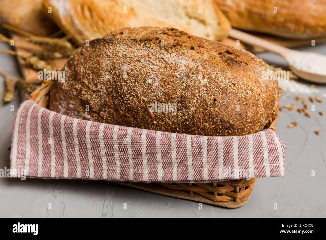 Homemade natural breads. Different kinds of fresh bread as background, perspective view with ...