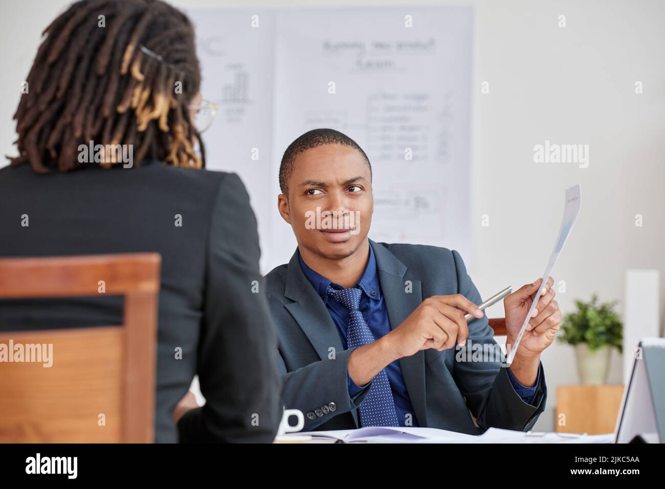 Handsome African American manager wearing classical suit sitting at ...