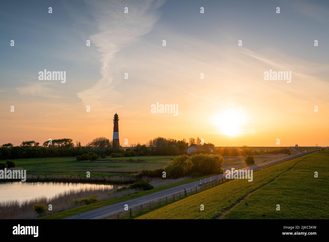 Panoramic image of Pellworm lighthouse against sunrise, North Frisia ...