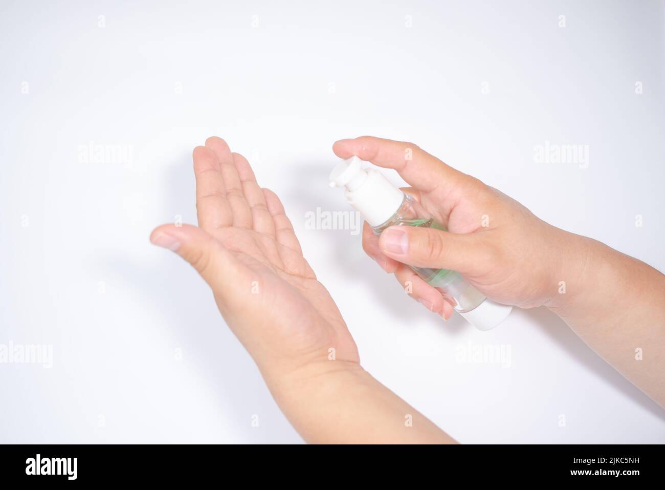 Hand disinfection. hand takes alcohol disinfectant spray on her hands ...