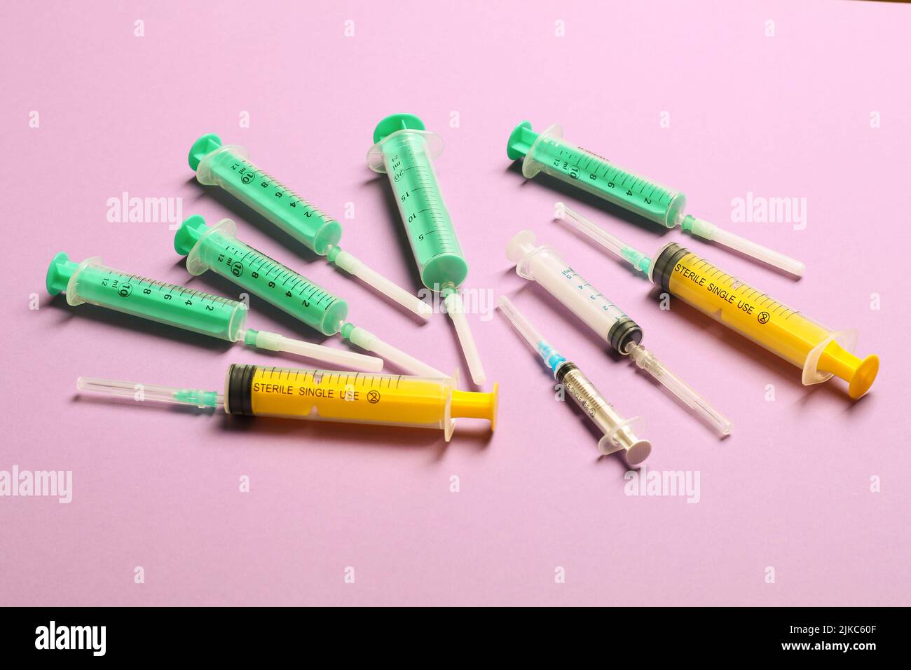 Top view of different syringes at purple background. Medical injection ...