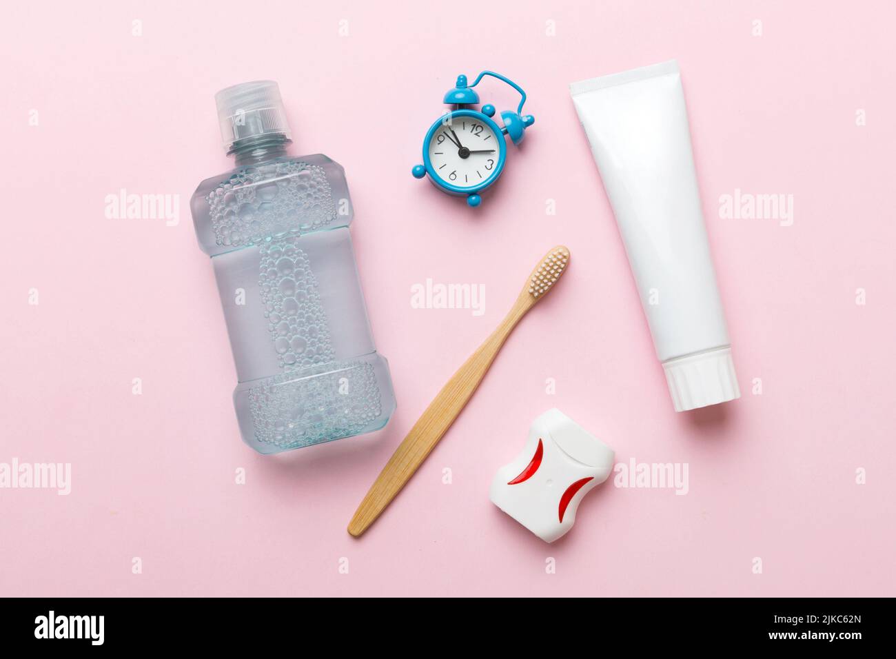 Mouthwash and other oral hygiene products on colored table top view ...