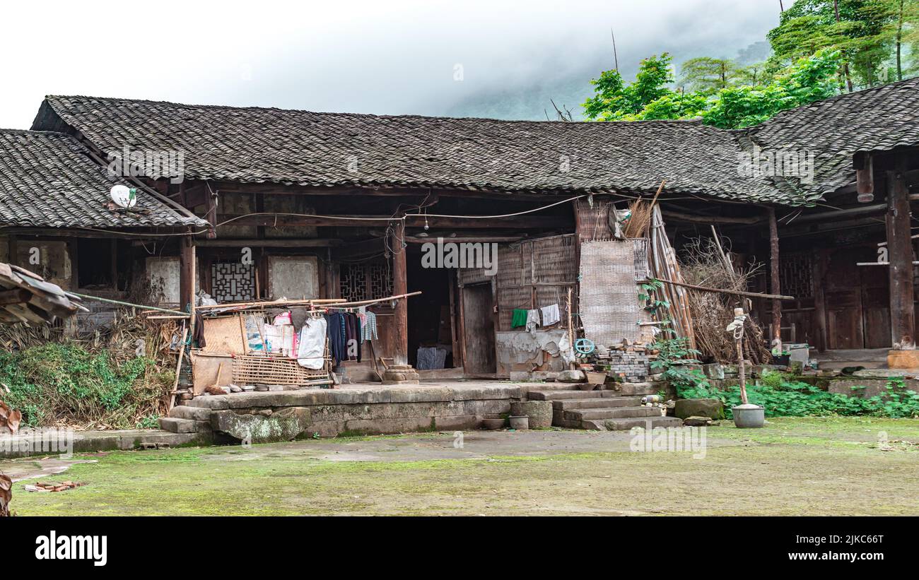 The facade of an old poor house in a village in the daytime Stock Photo ...