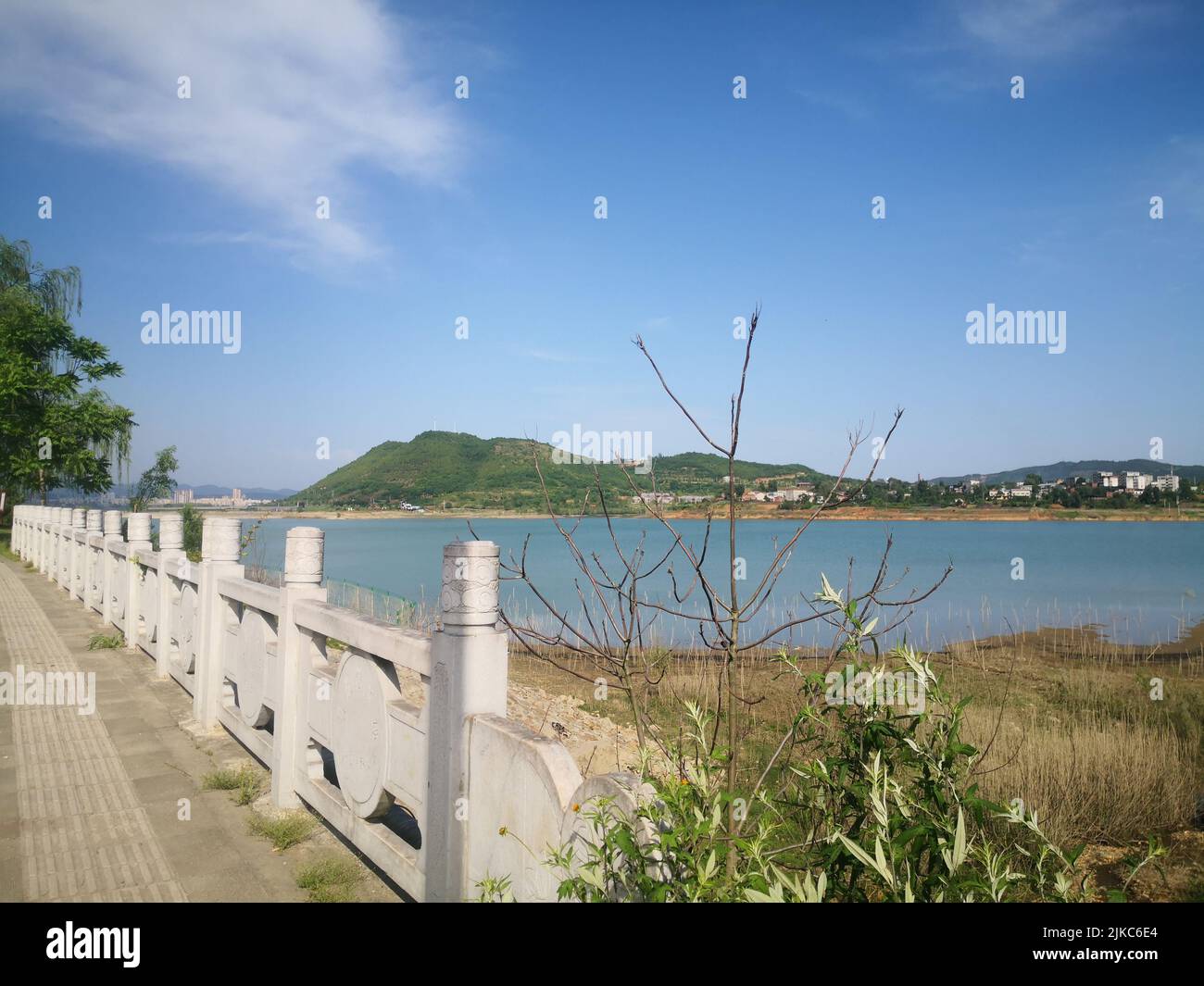 A pretty waterscape with a walkway and townscape on the other coast ...