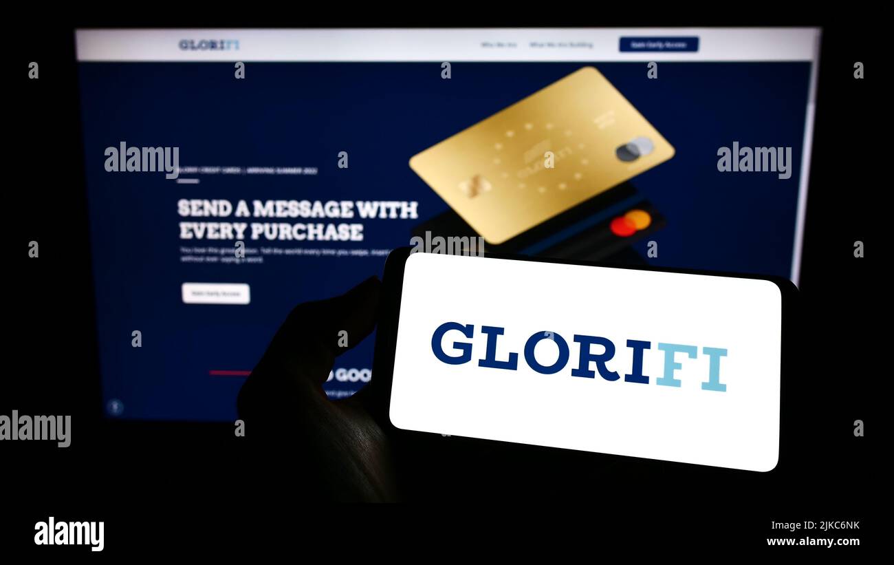 Person holding mobile phone with logo of company Animo Mortgage Company ...