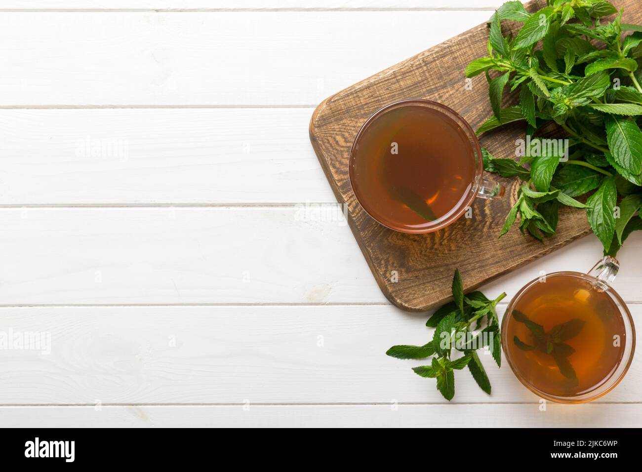 Cup of mint tea on table background. Green tea with fresh mint top view ...
