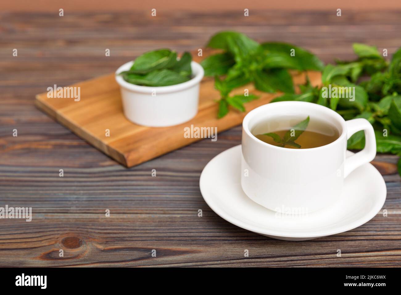 Cup of mint tea on table background. Green tea with fresh mint top view ...