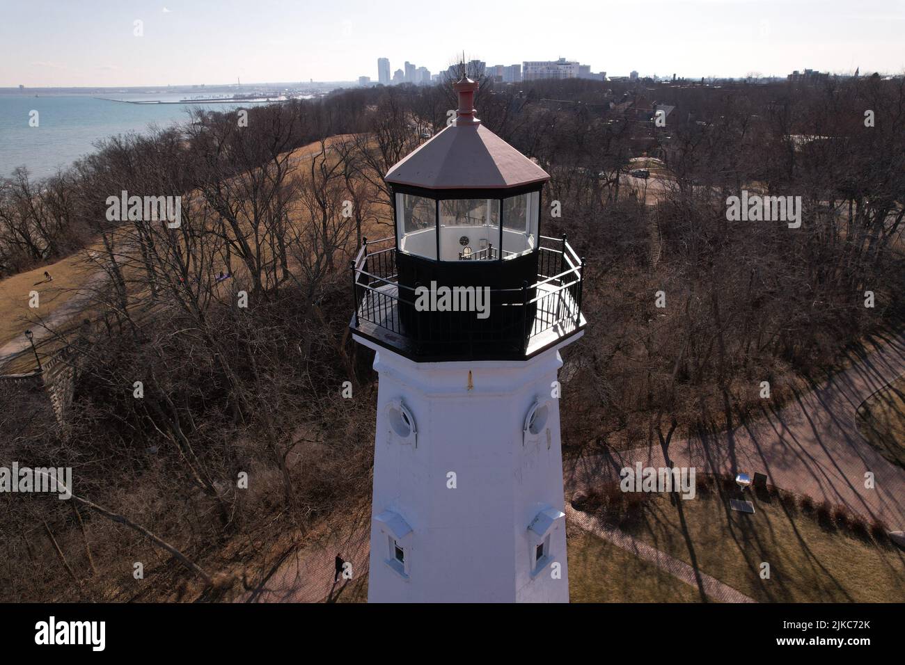An aerial view of a white Lighthouse surrounded by dry trees Stock ...