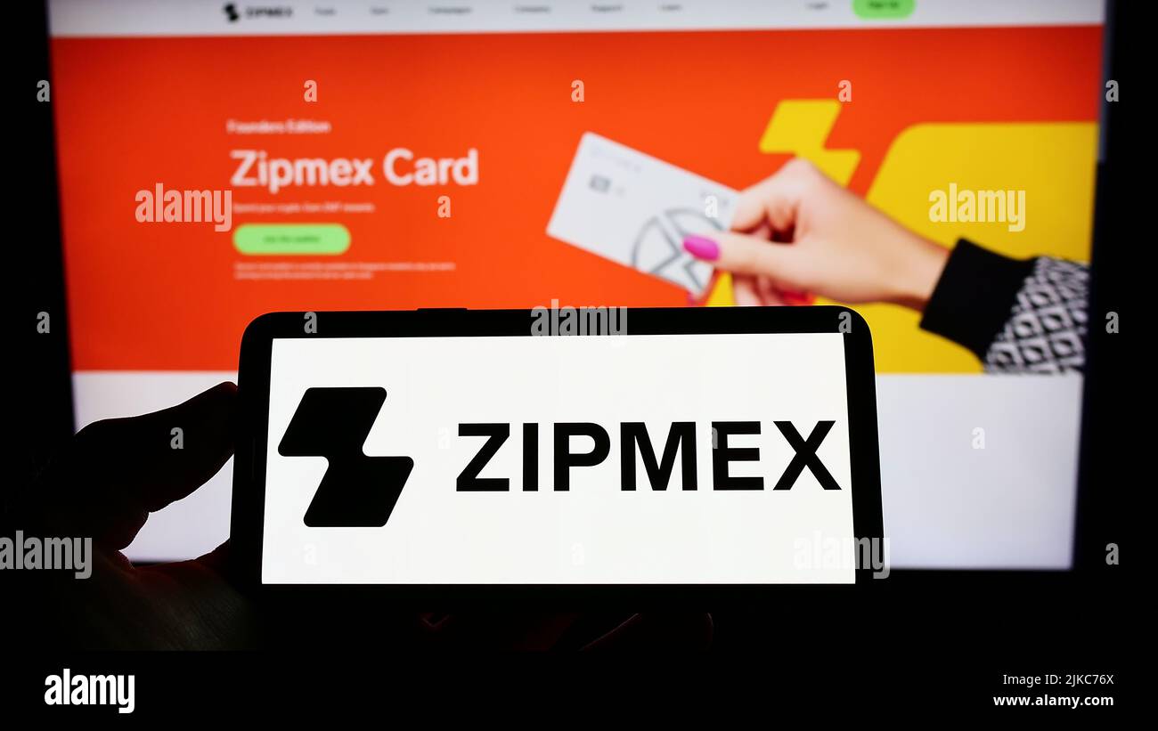Person holding cellphone with logo of Singaporean crypto company Zipmex ...