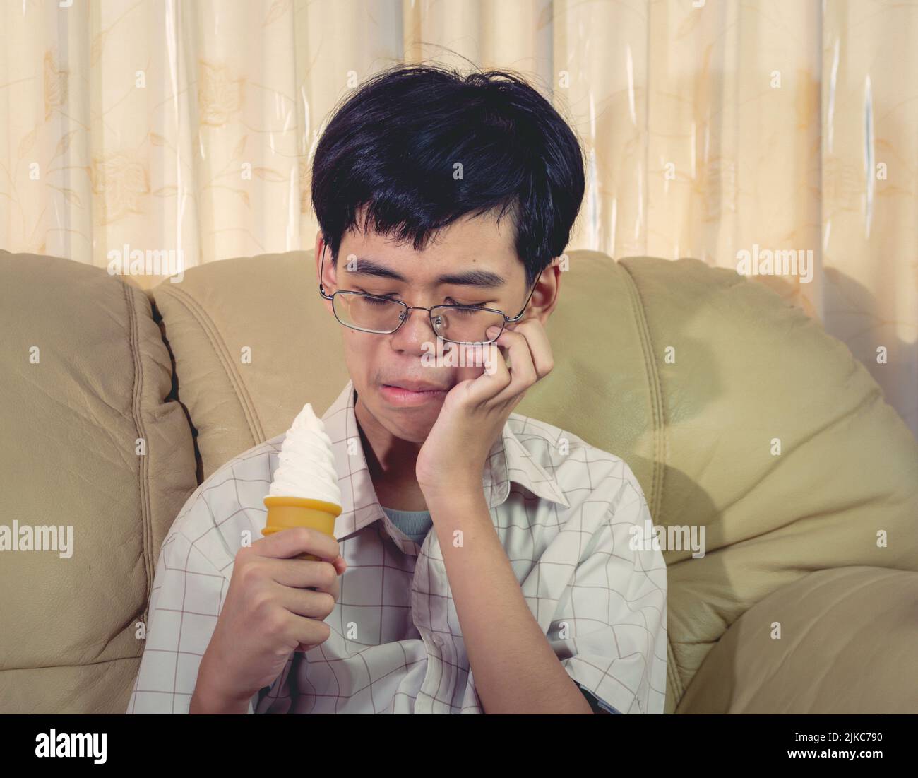 Asian young man with sensitive teeth and cold ice cream because eating ...