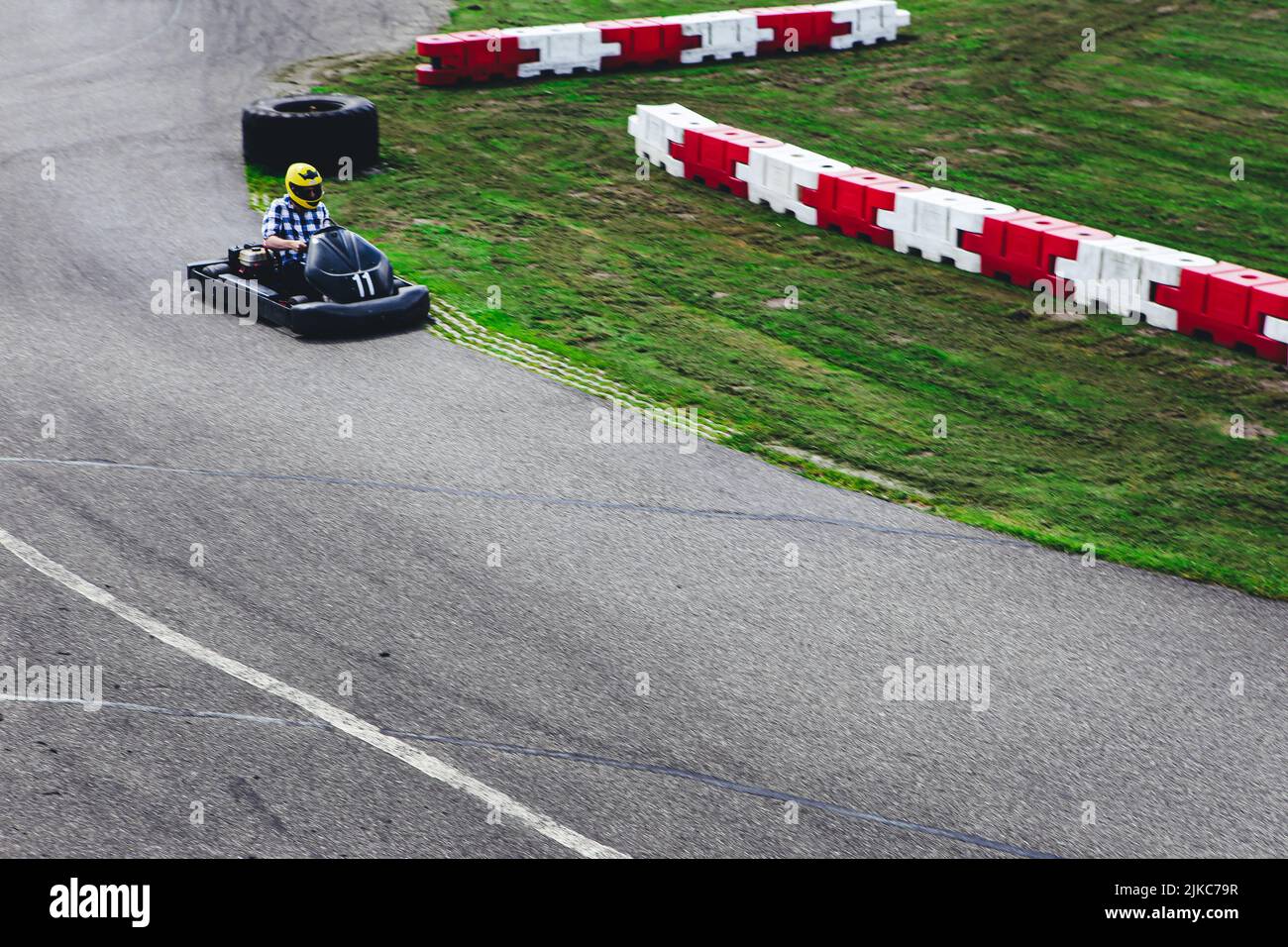 a kart driver drifting on race track Stock Photo - Alamy