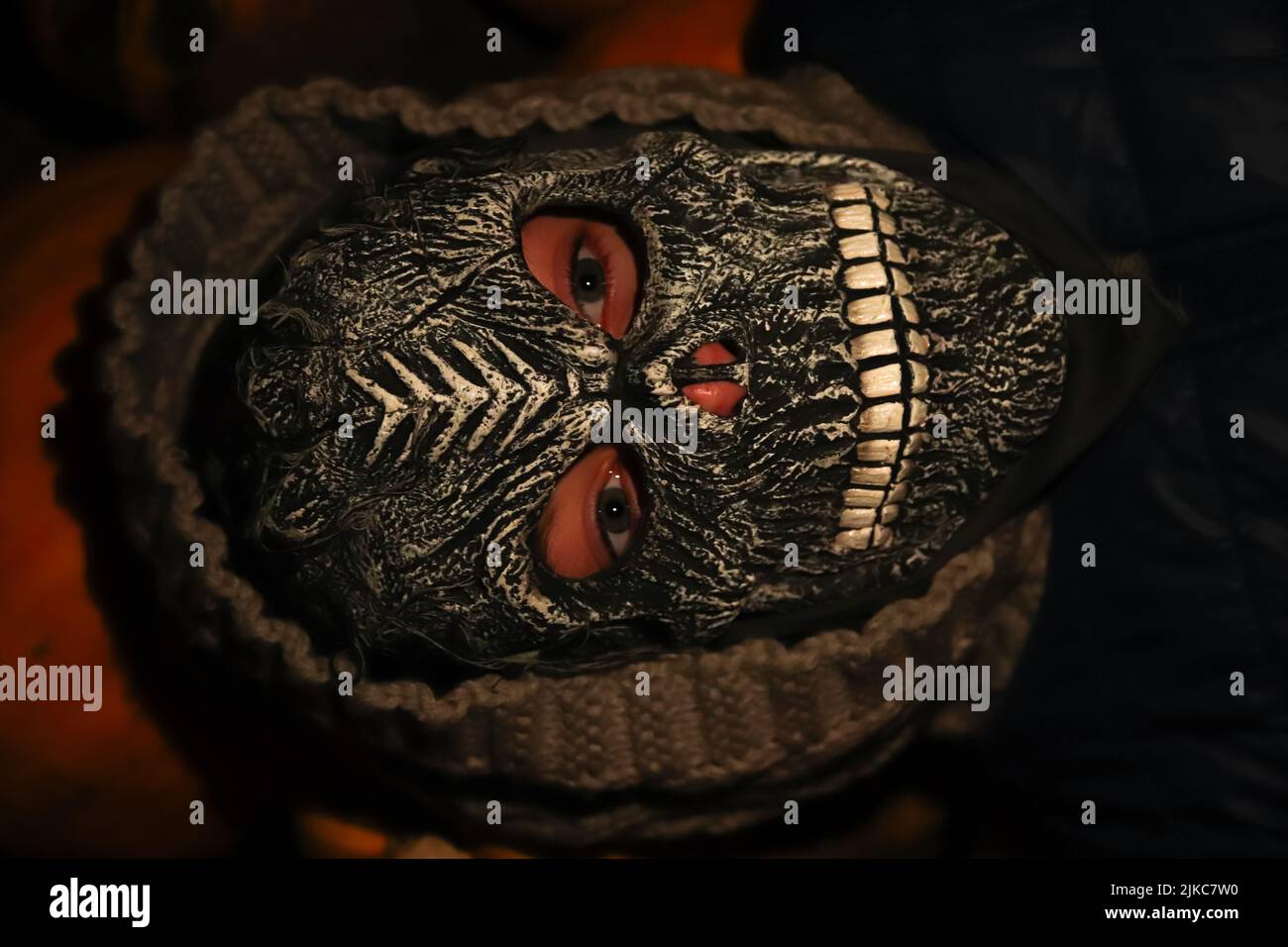 Defocus Halloween people. Person in grim reaper mask standing on black ...