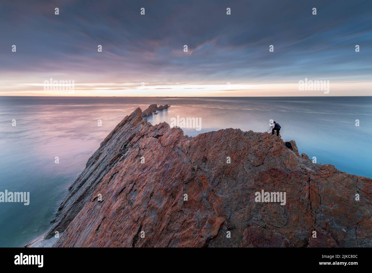An aerial view of photographer standing on rock formation surrounded by ...