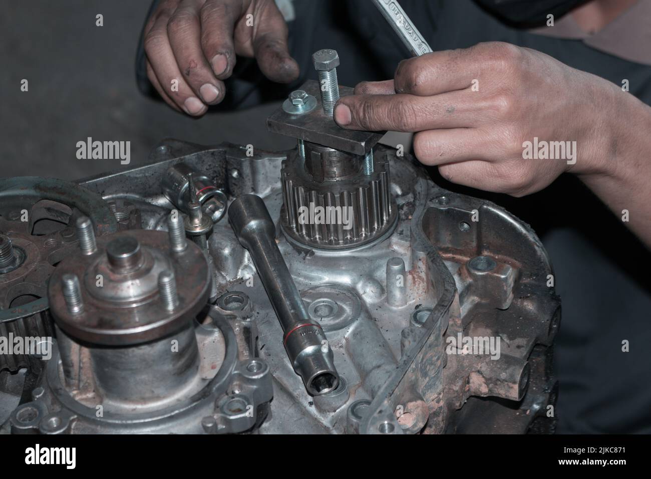 a close up of auto mechanic's hands repairing car troubleshooting with ...
