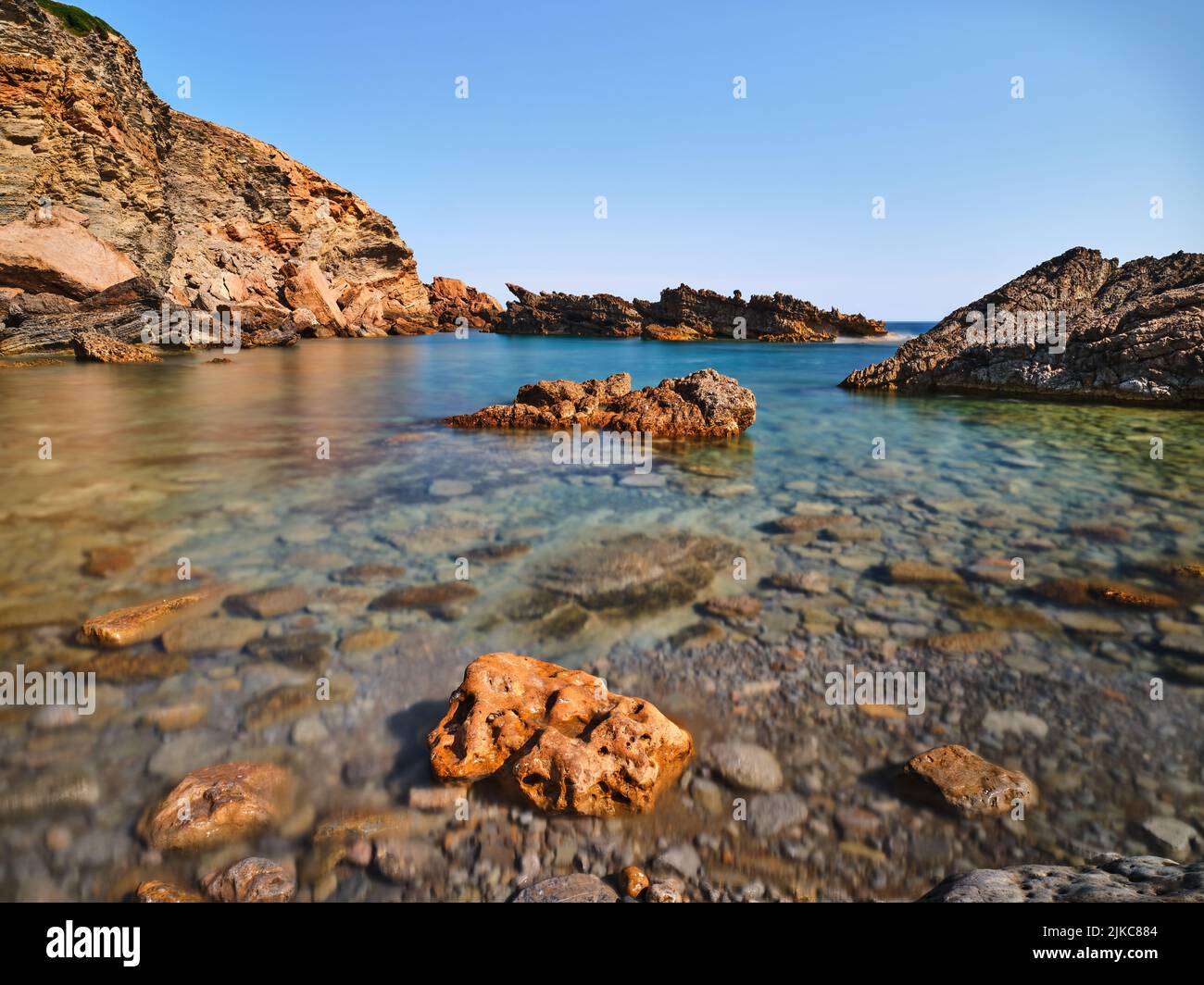 Rocks and sea in long exposure in Menorca, Spain Stock Photo - Alamy