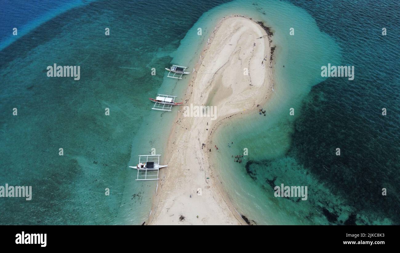 A top view of tranquil, isolated sandy beach on a tropical island ...