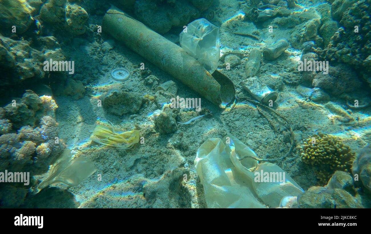 Seabed of beautiful coral reef covered with plastic and other garbage ...