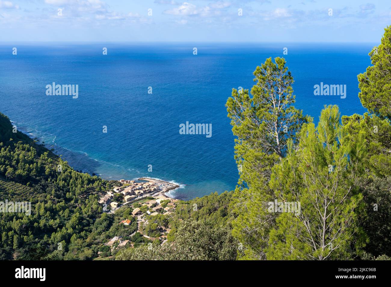 An aerial view of the blue water on the shore of Port de Valldemossa ...