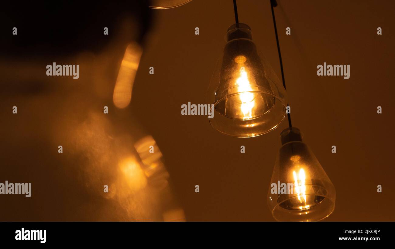 Light bulbs hang on ceiling hi-res stock photography and images - Alamy