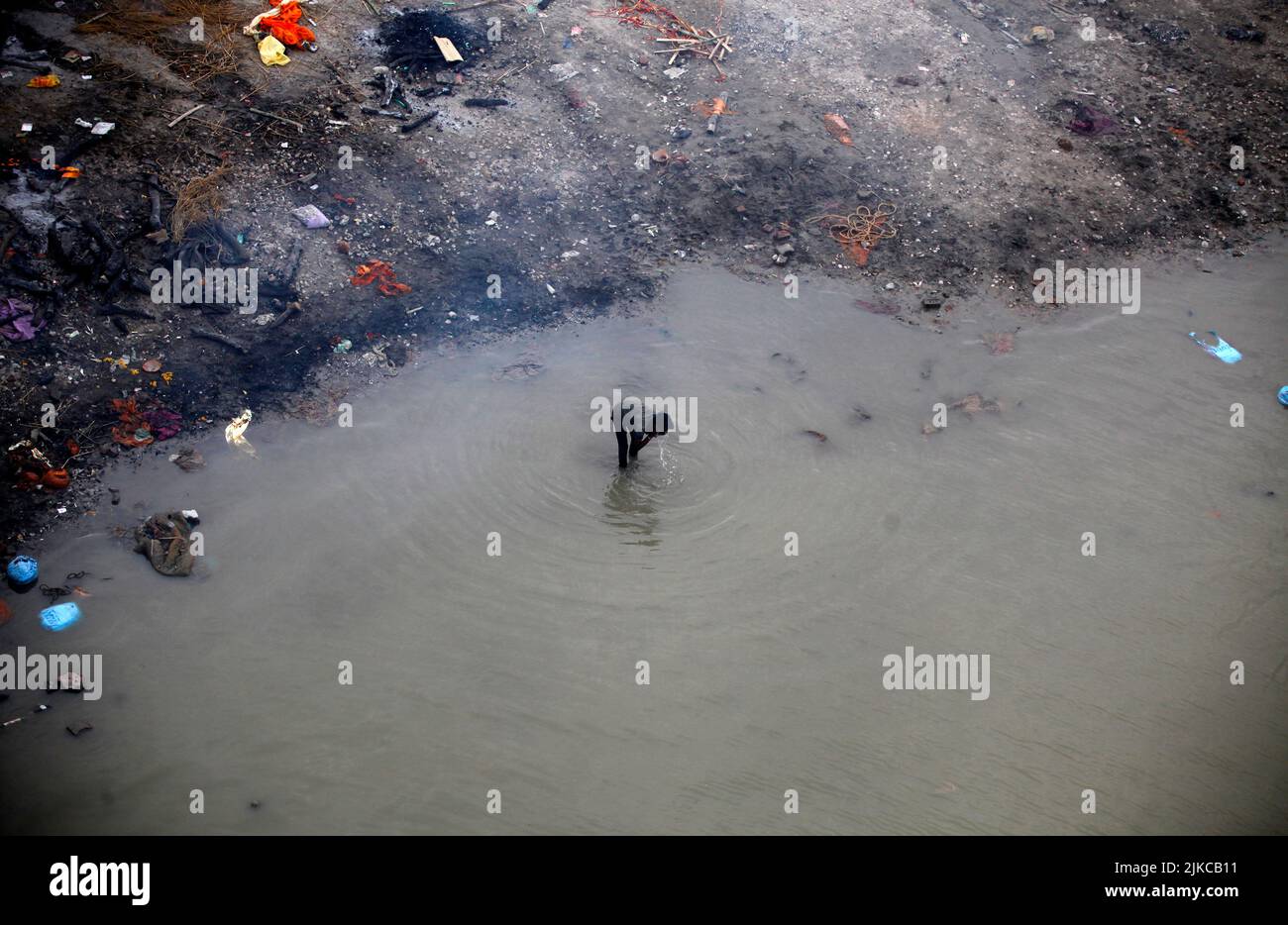 Prayagraj, India. 01/08/2022, An indian wash his face in the polluted ...