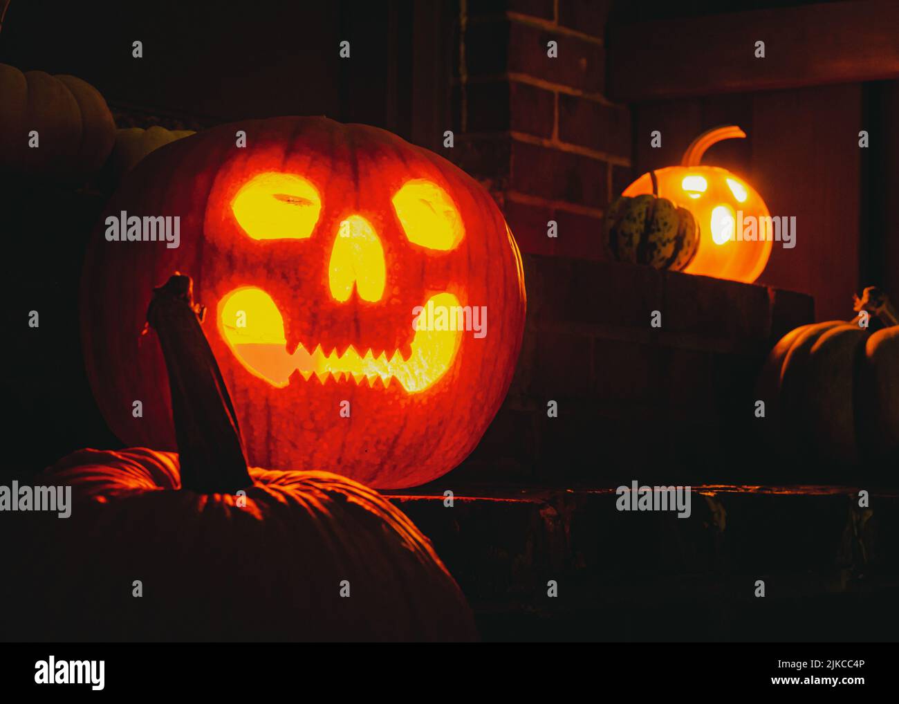 Lighted Jack-o-lanterns on a doorstep on a Halloween night Stock Photo ...