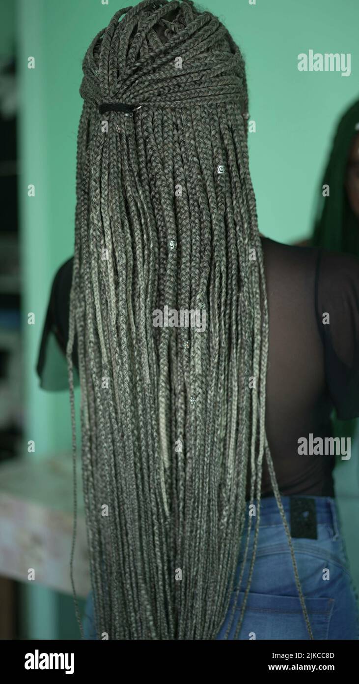 A black latina girl with dreadlocks hair. An African woman plays with ...