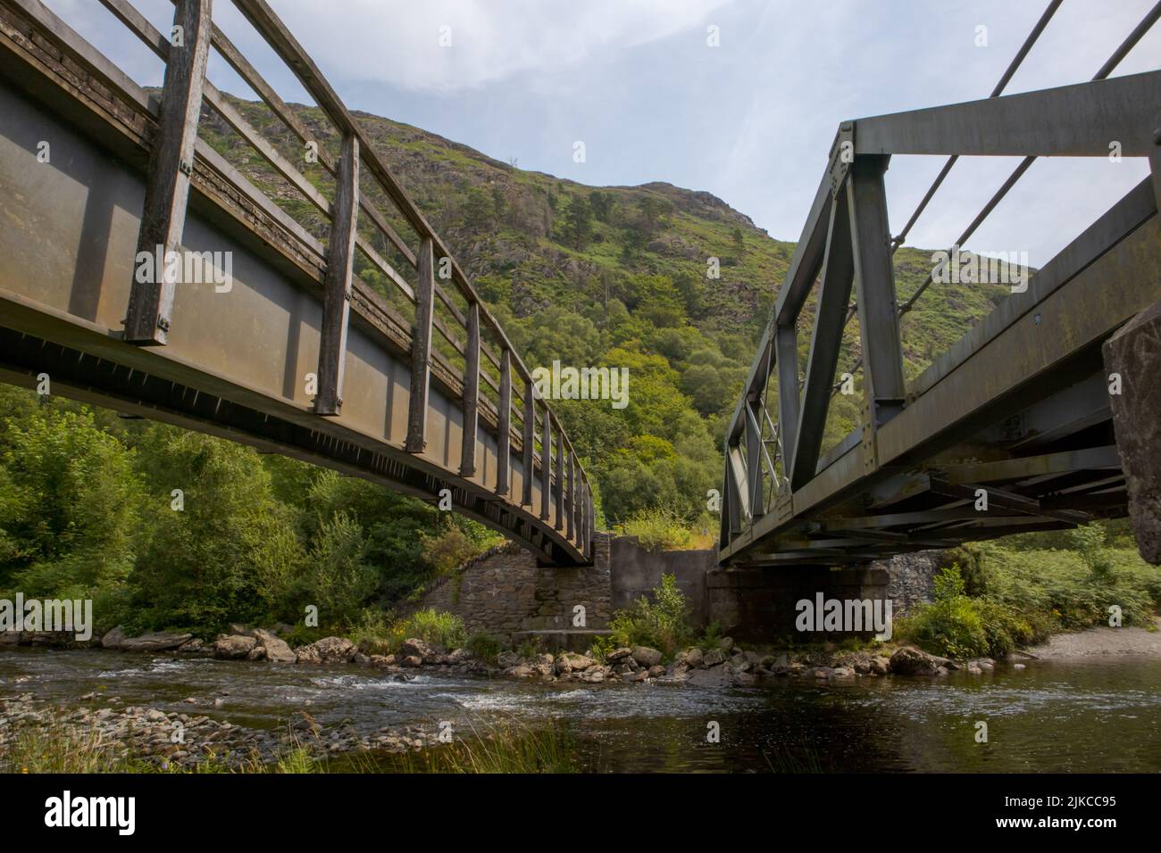 A green mountain through bridges Stock Photo - Alamy