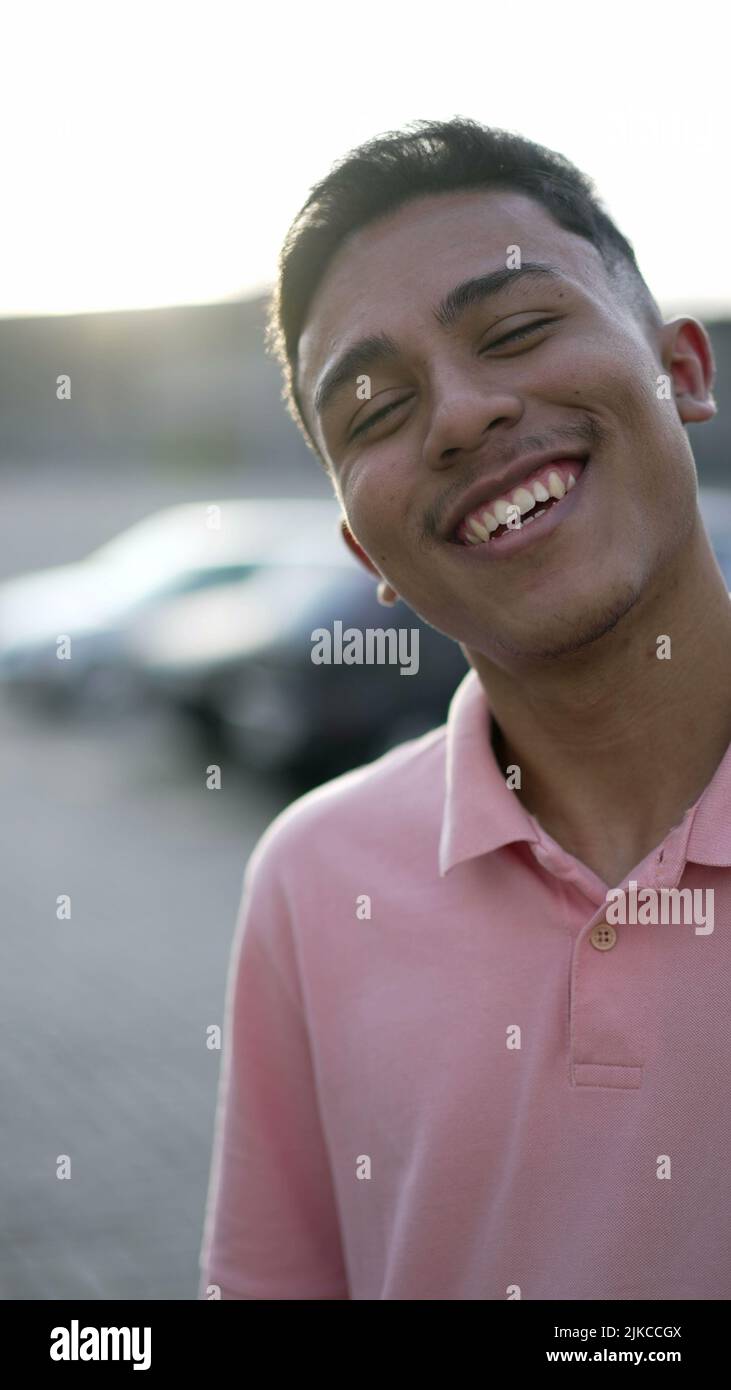 Portrait of a happy hispanic south american young man laughing and ...