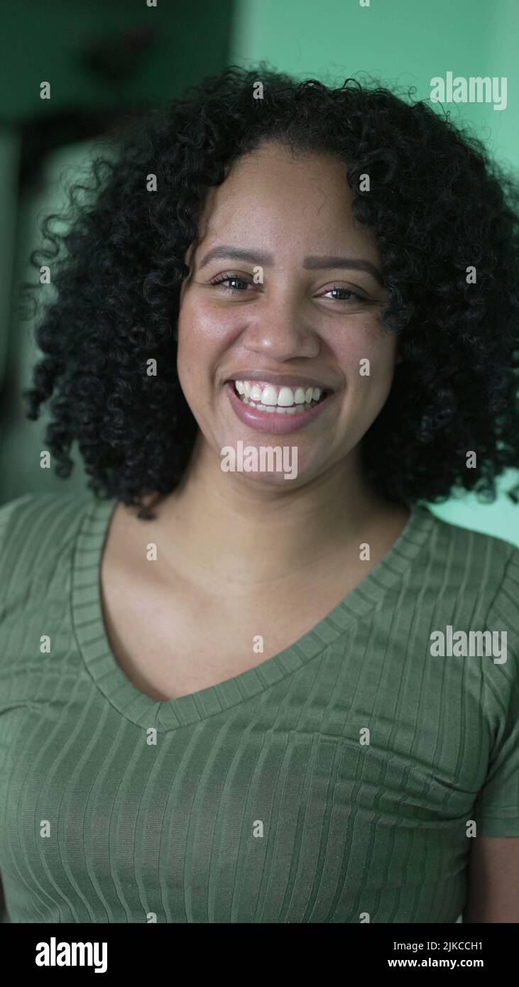 Portrait of a happy black woman smiling at camera. a hispanic latin ...
