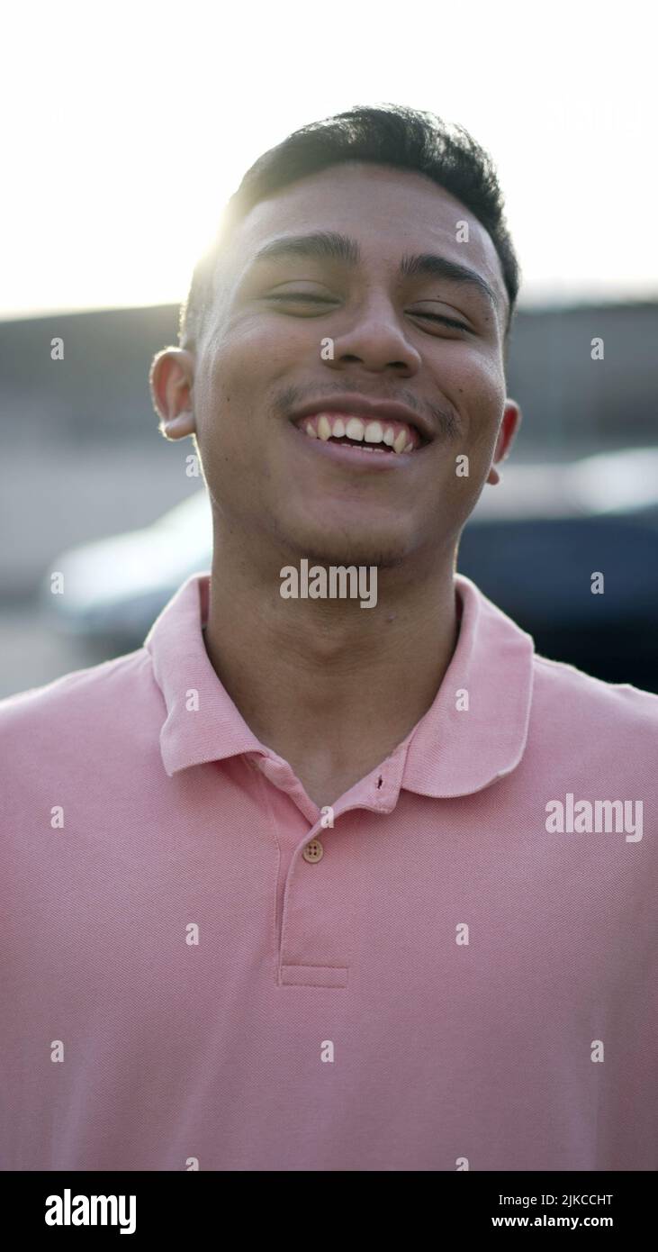 Portrait of a happy hispanic south american young man laughing and ...