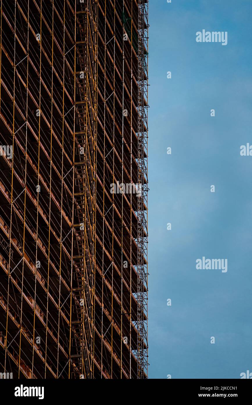 A vertical low angle of a metal construction against blue sky ...