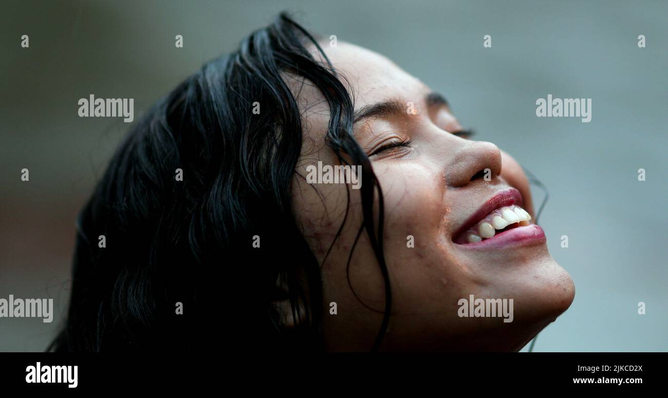 Happy young woman face feeling the rain droplet on face outside Stock ...