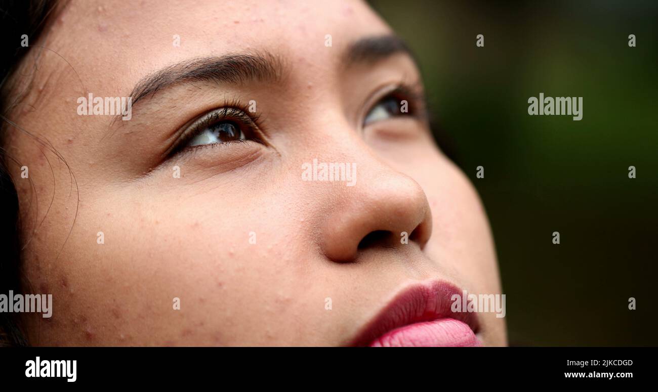 Hispanic young woman face looking up to sky with HOPE and FAITH Stock ...