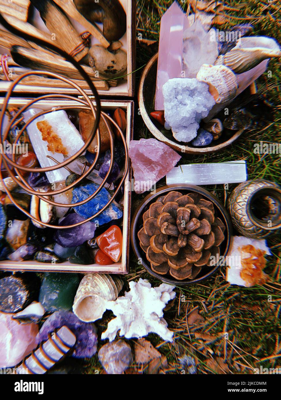 A vertical shot of crystal stones, palo santo, and smudge sticks for ...