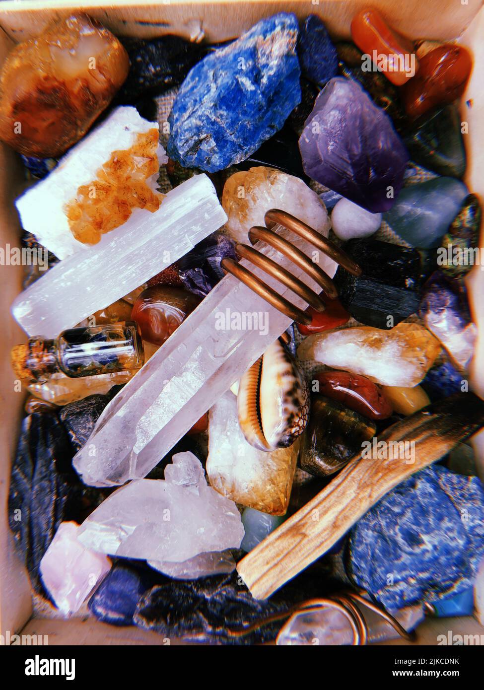 A vertical shot of crystals, palo santo and seashells in a box Stock ...