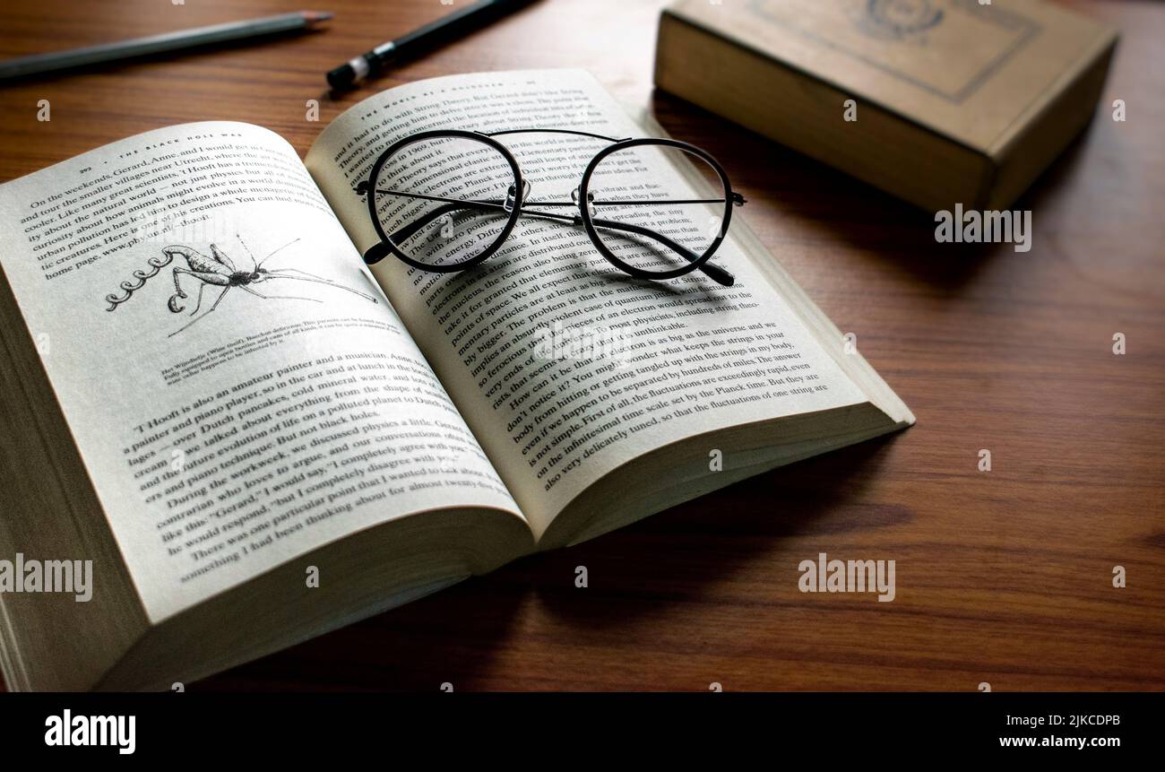 Specs on book hi-res stock photography and images - Alamy